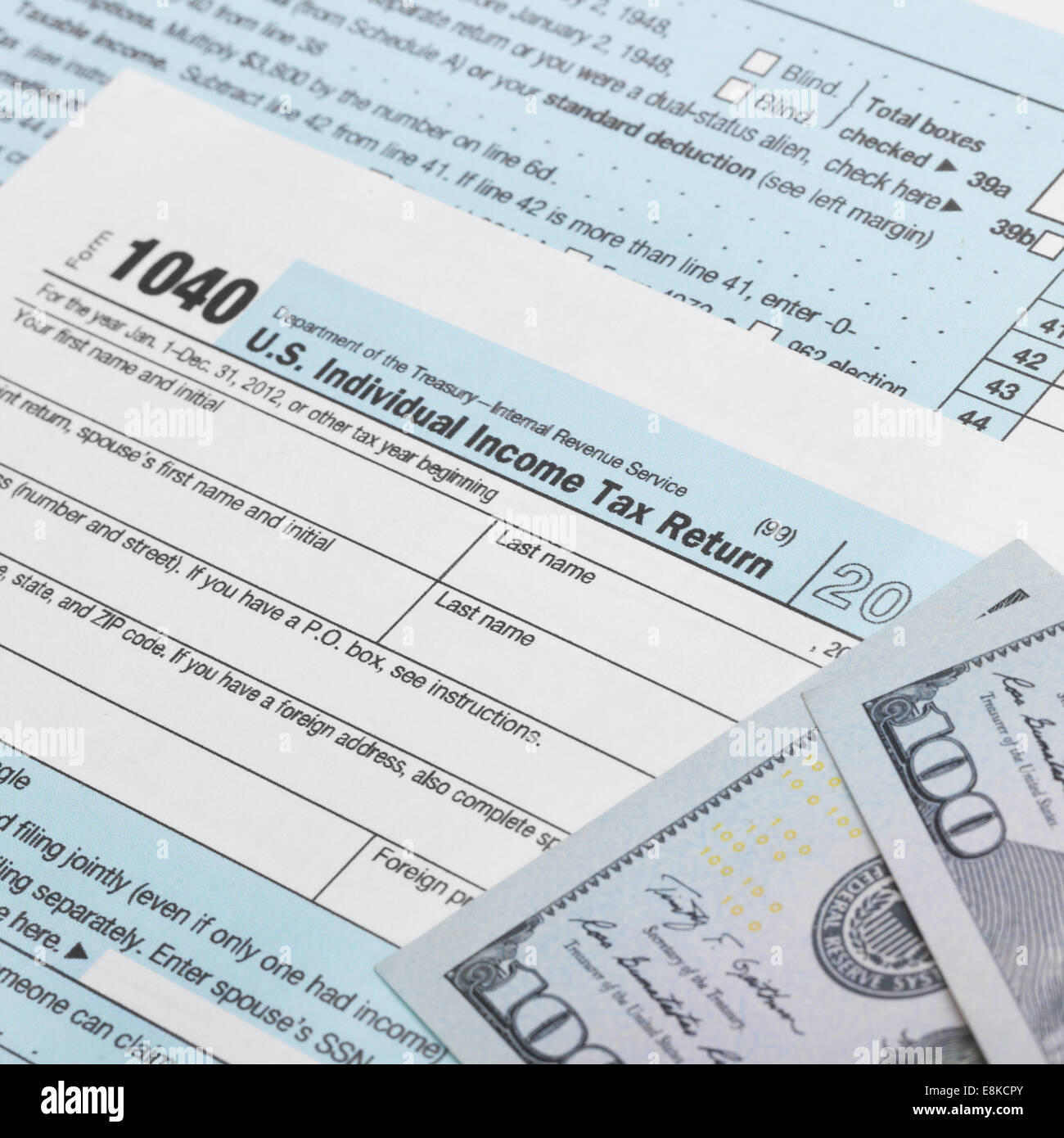 US Tax Form 1040 with 100 dollars bills - 1 to 1 ratio Stock Photo - Alamy