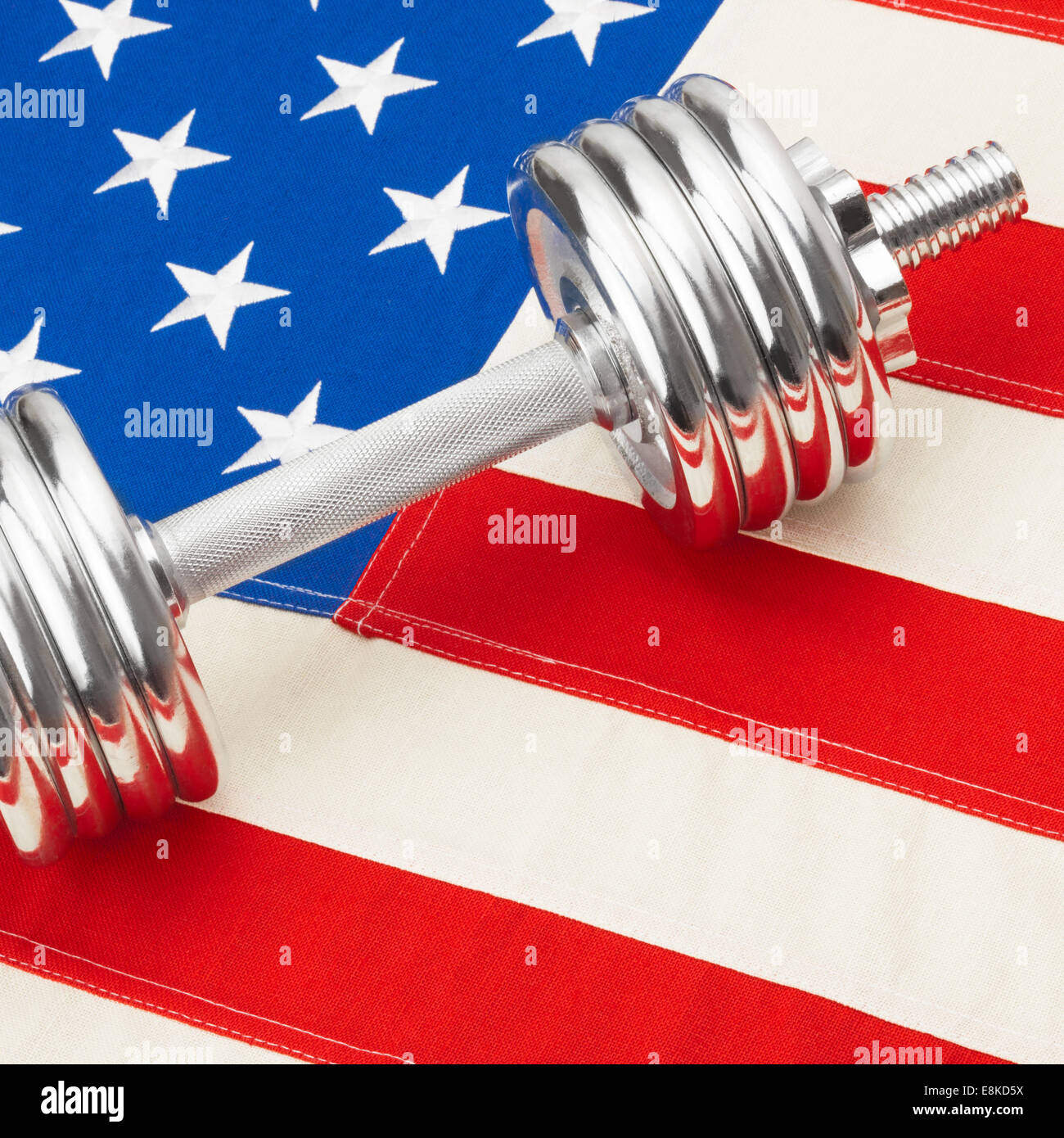 USA flag and metal dumbbells as symbol of healthy nation - studio shot ...