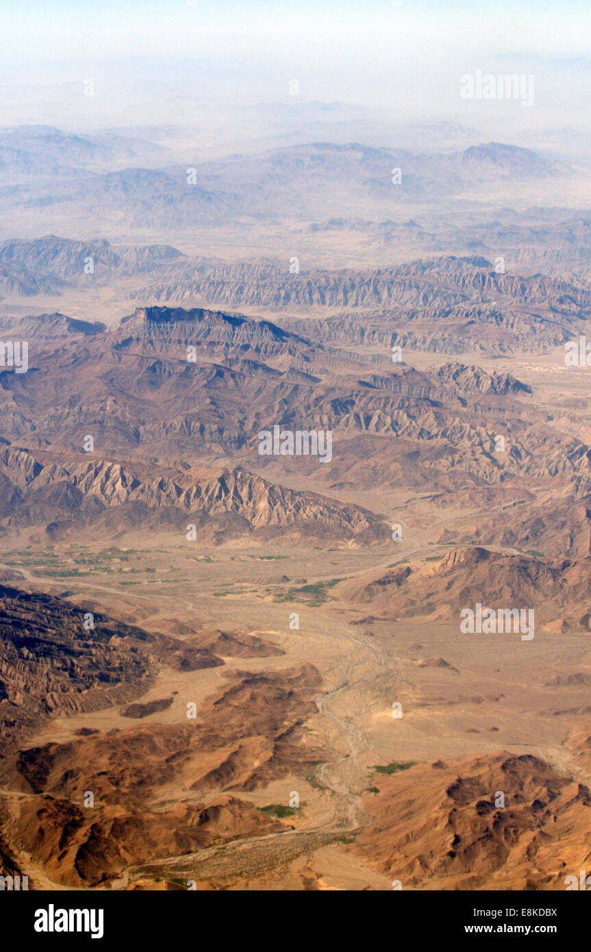 Aerial of long distant mountainous & barren desert-like barren ...