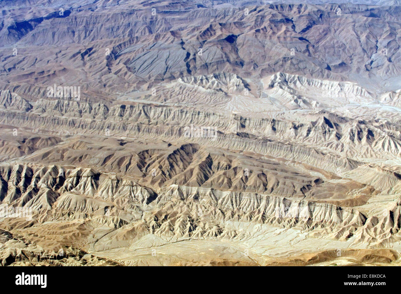 Aerial of long distant mountainous & barren desert-like barren ...