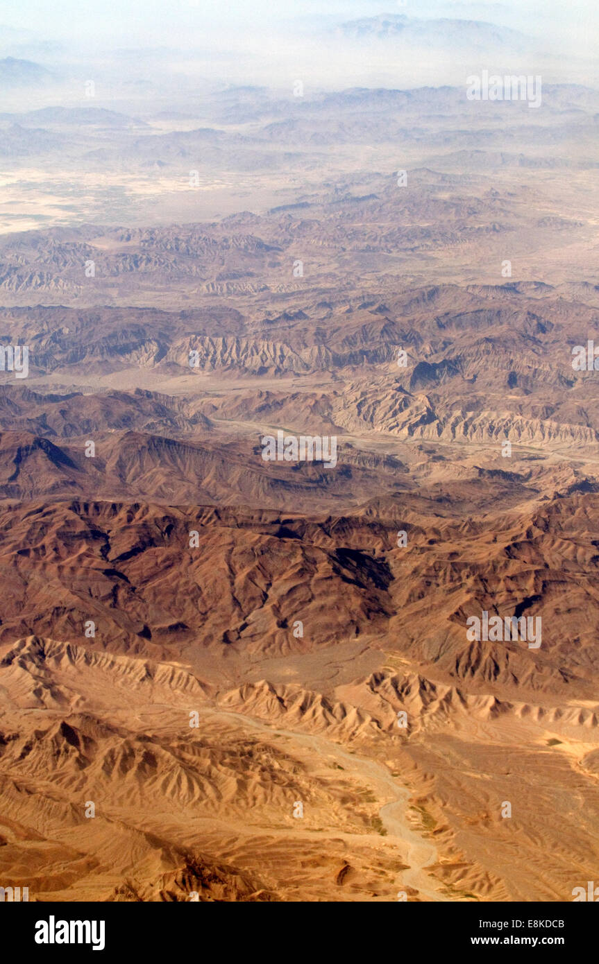 Aerial of long distant mountainous & barren desert-like barren ...
