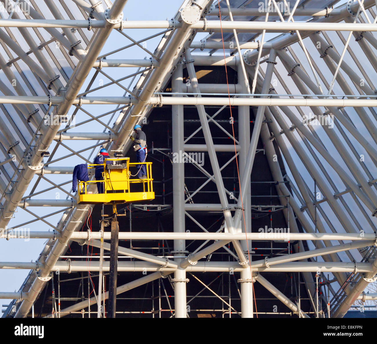 Workers lifted in air build grand steel roof construction of new ...