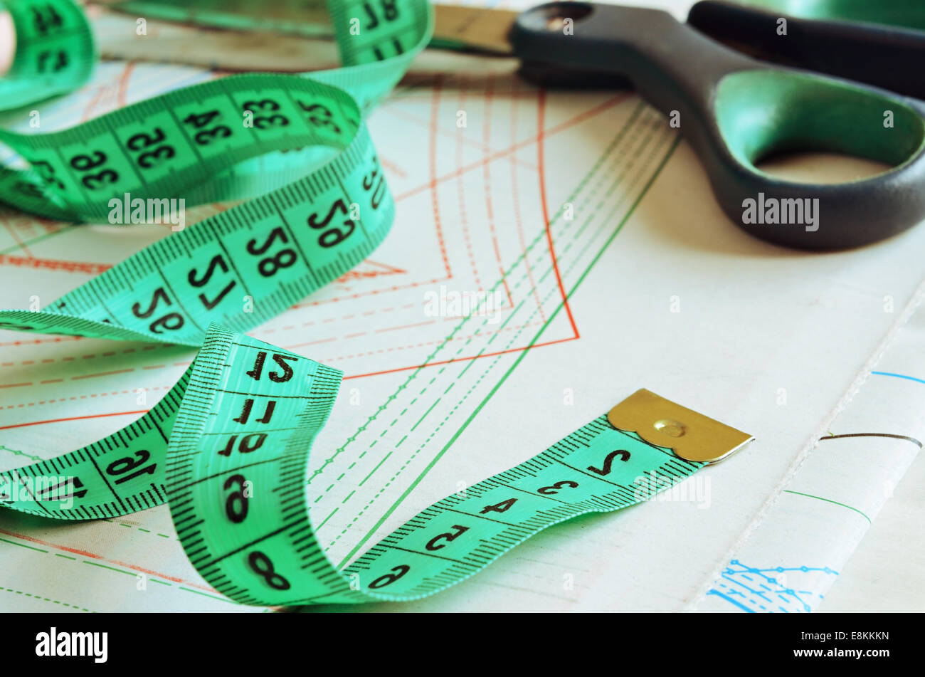 Measuring tape and scissors on dress patterns Stock Photo - Alamy