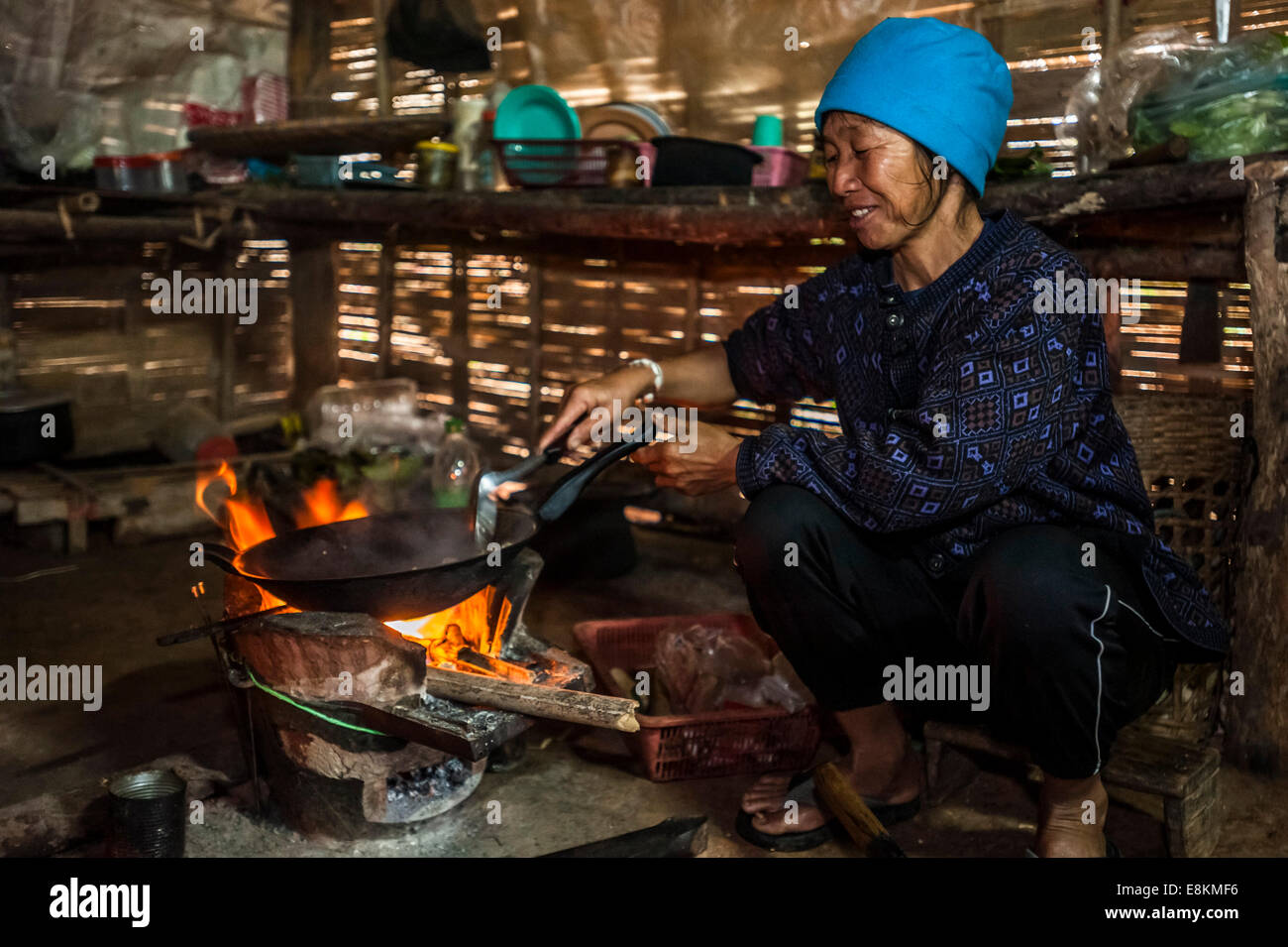 Woman from the Lahu people, hill tribe, ethnic minority, cooking on an ...