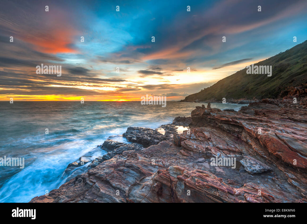 sunset waves lash line impact rock on the beach and fog Stock Photo - Alamy