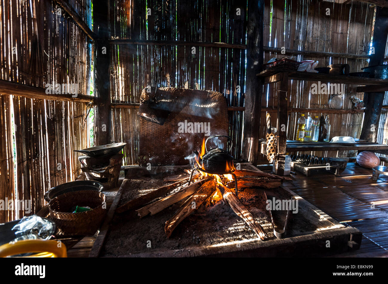 Kettle over an open fire in a kitchen made of bamboo, Lahu village ...
