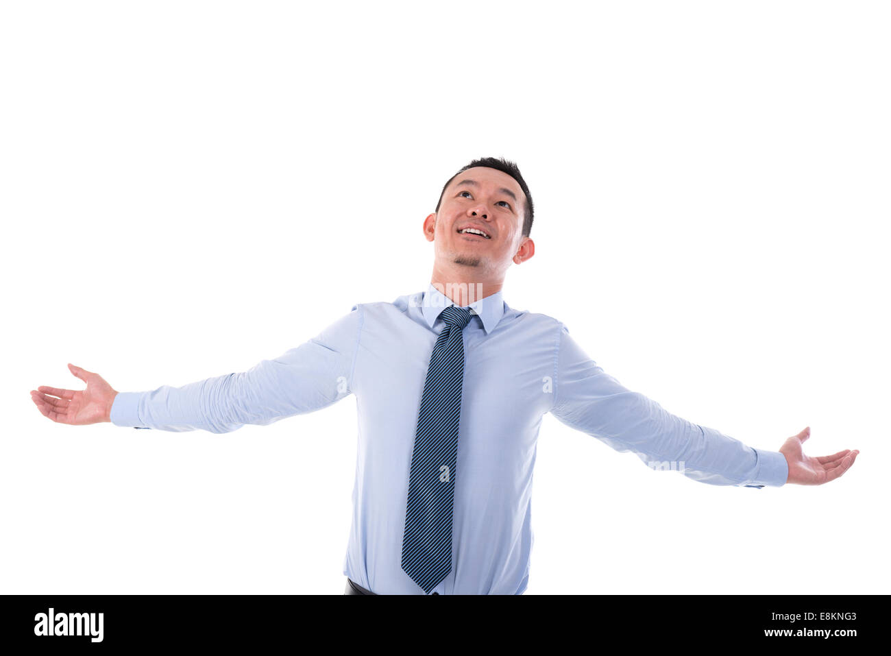 Asian business man open arms outstretched, looking up, isolated over ...