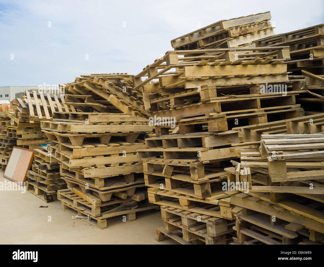 Pile of used pallets stacked in an industrial backyard Stock Photo - Alamy