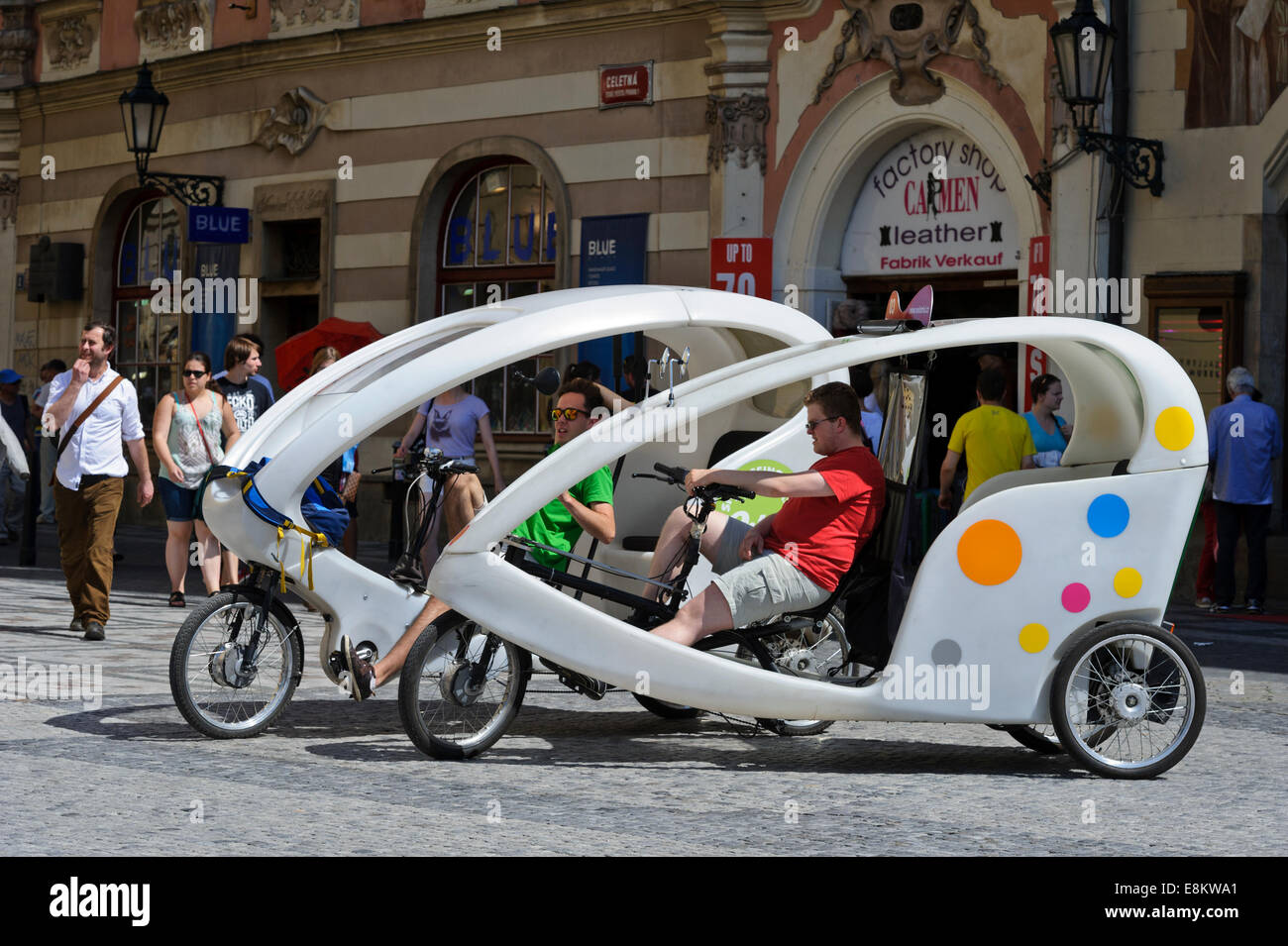 Two modern white rickshaws in the Old Town Square in Prague, Czech ...