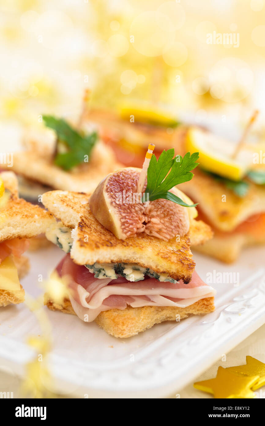 Star shaped toasts with smoked salmon,procsiutto and cheese Stock Photo ...