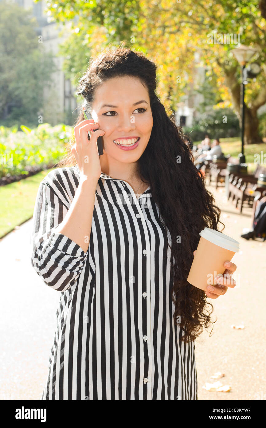 young woman enjoying a coffee and phone call Stock Photo - Alamy