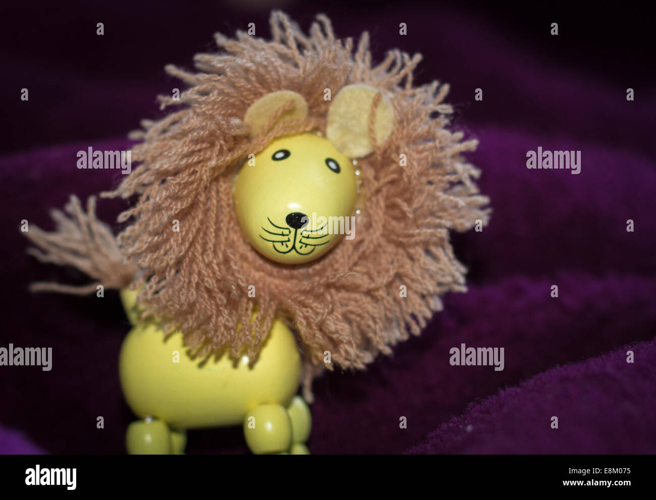 Yellow, pop-up, beaded lion puppet with a woolly mane Stock Photo - Alamy