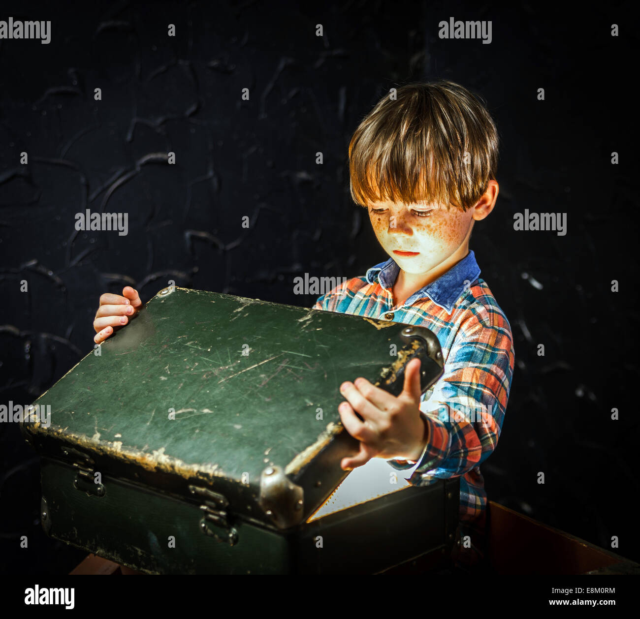 Little boy finding treasure inside a suitcase Stock Photo - Alamy