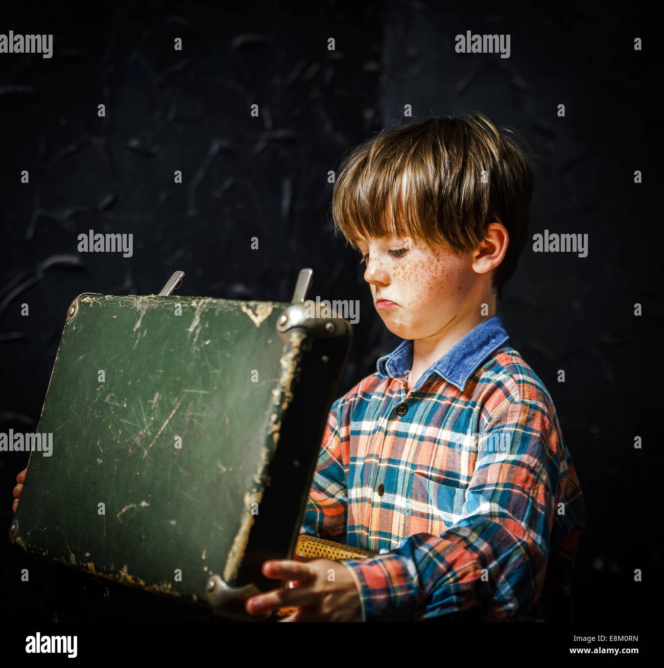 Little boy finding treasure inside a suitcase Stock Photo - Alamy