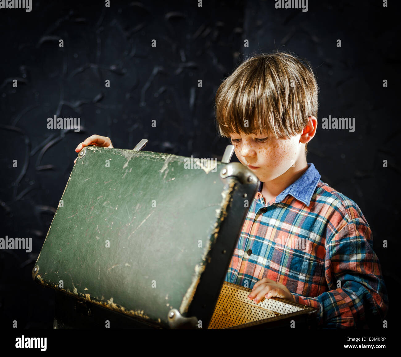 Little boy finding treasure inside a suitcase Stock Photo - Alamy