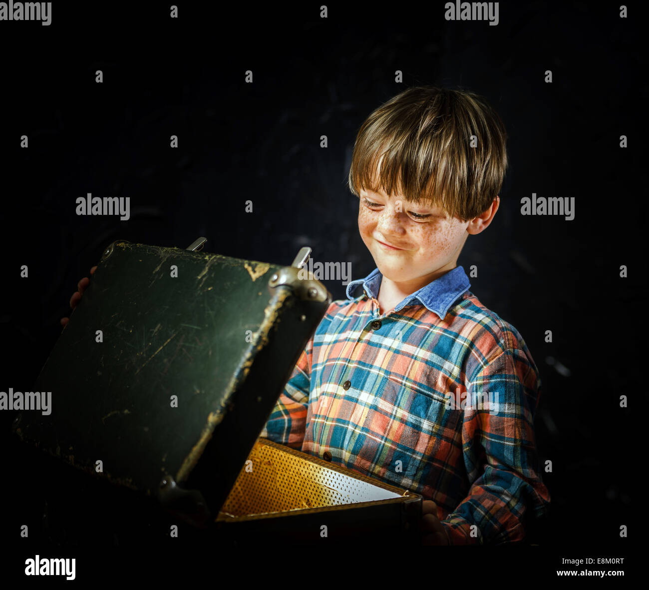 Little boy finding treasure inside a suitcase Stock Photo - Alamy