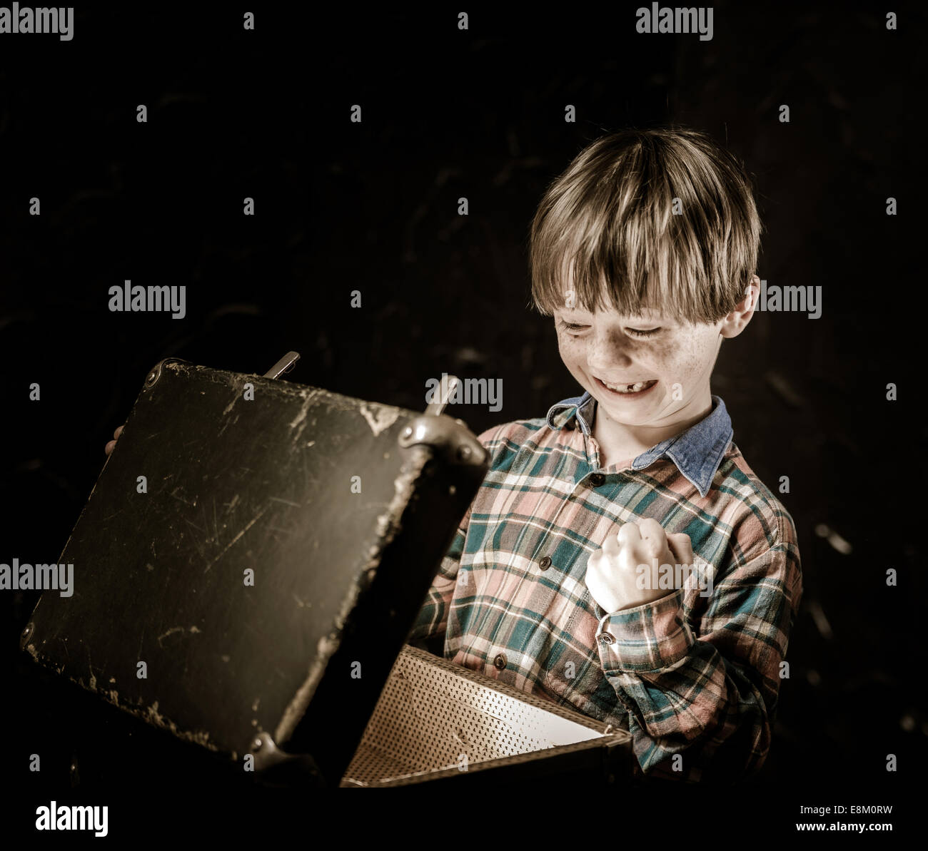 Little boy finding treasure inside a suitcase Stock Photo - Alamy