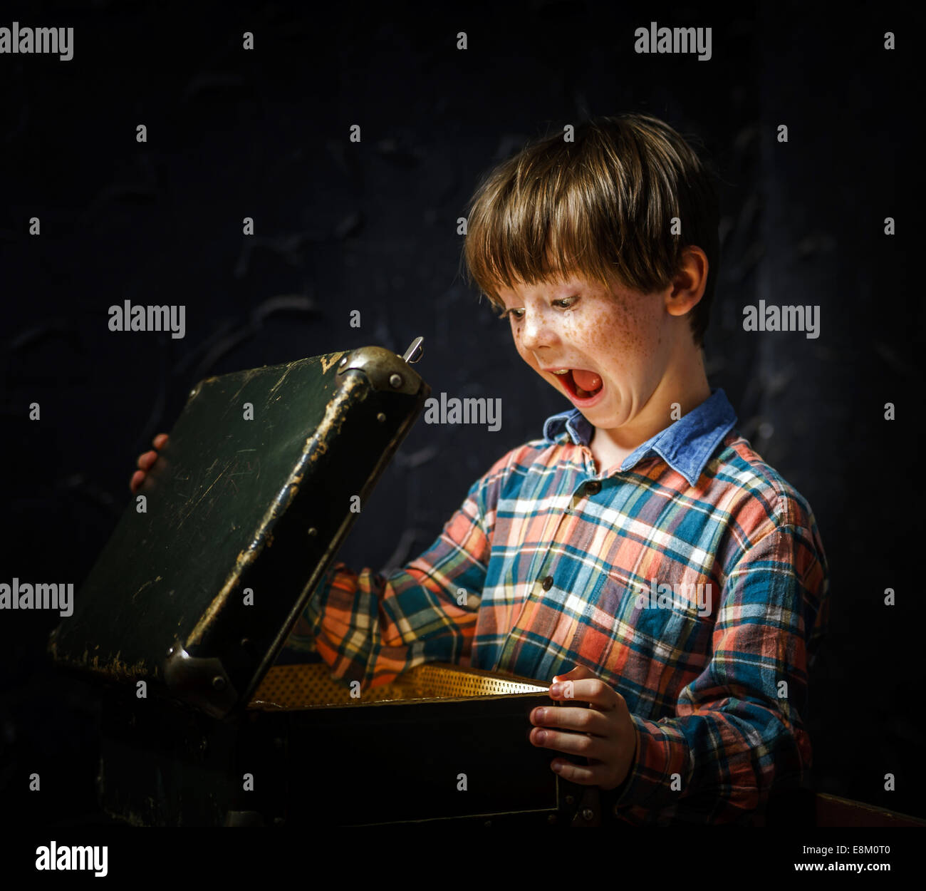 Little boy finding treasure inside a suitcase Stock Photo - Alamy