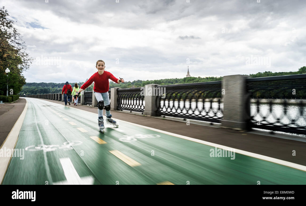 Beautiful teenage girl roller-skating fast in public park Stock Photo ...