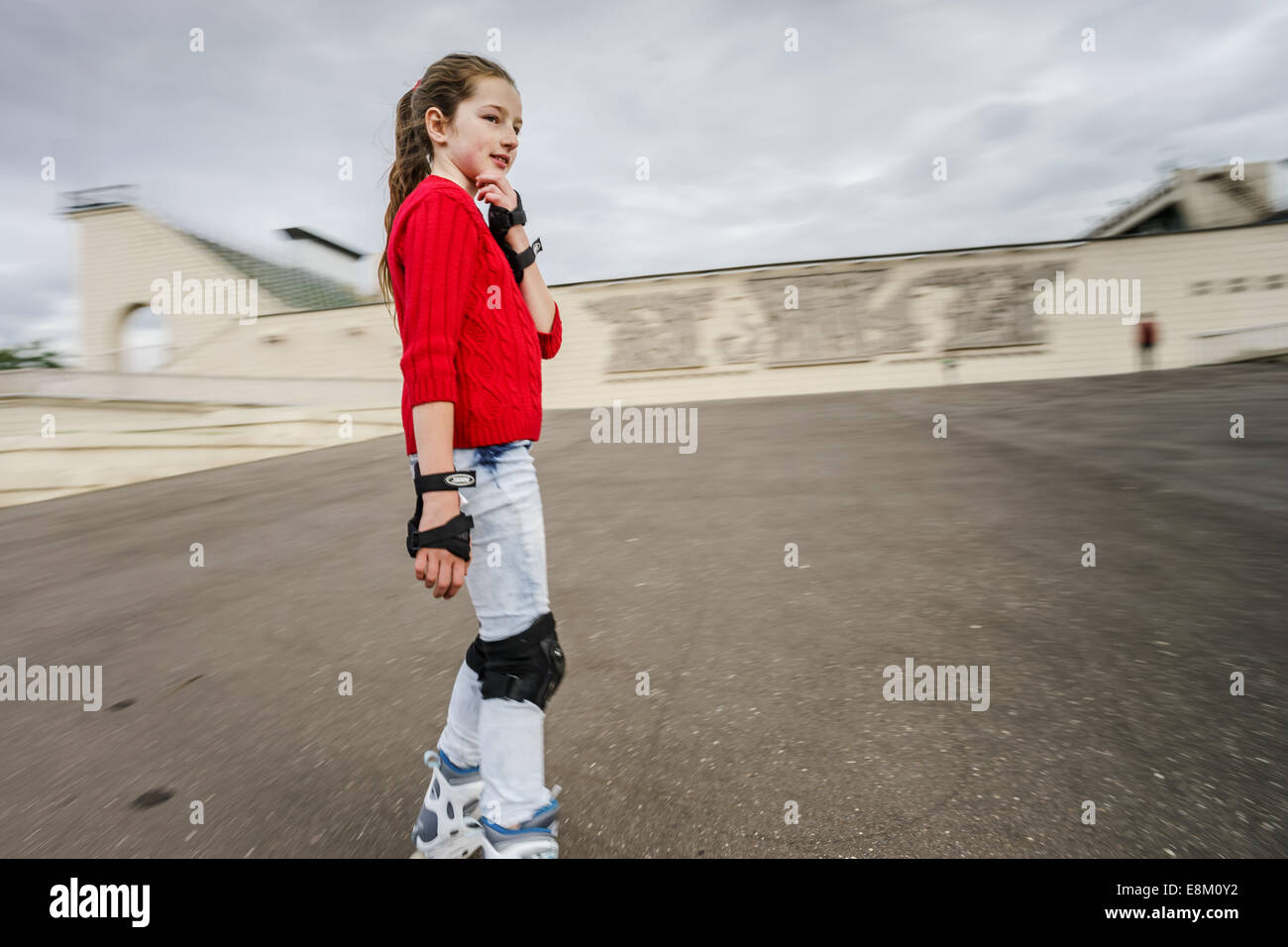 Beautiful teenage girl roller-skating fast in public park Stock Photo ...