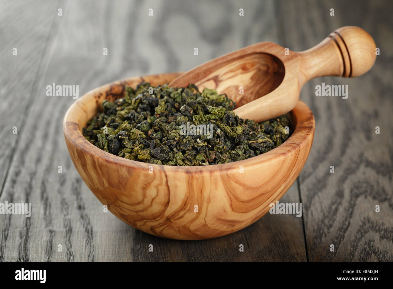 oolong green tea in wood bowl, on oak table Stock Photo - Alamy