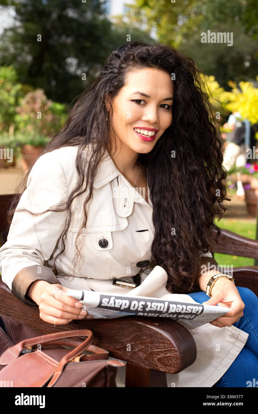 young woman reading the paper Stock Photo - Alamy