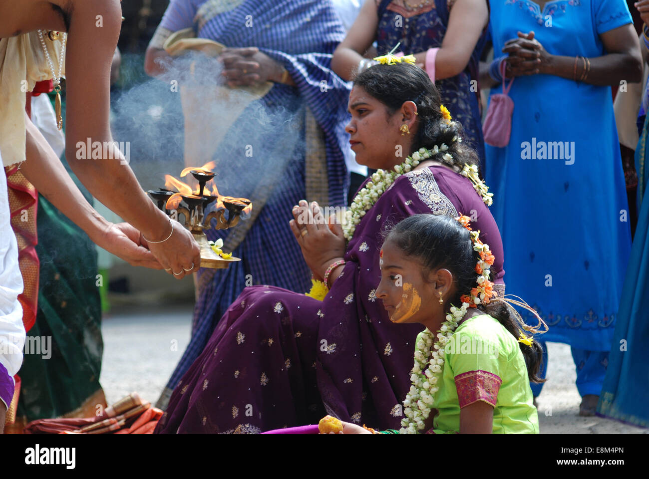 Mother and child devotee in blessing ritual by priest on Hindu festival ...