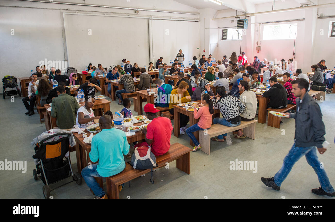 Munich, Germany. 10th Oct, 2014. Refugees get food in the cafeteria at ...
