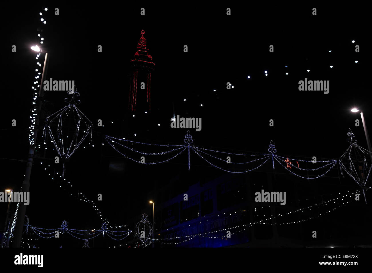Night view towards red Blackpool Tower rising above blue LED lights ...