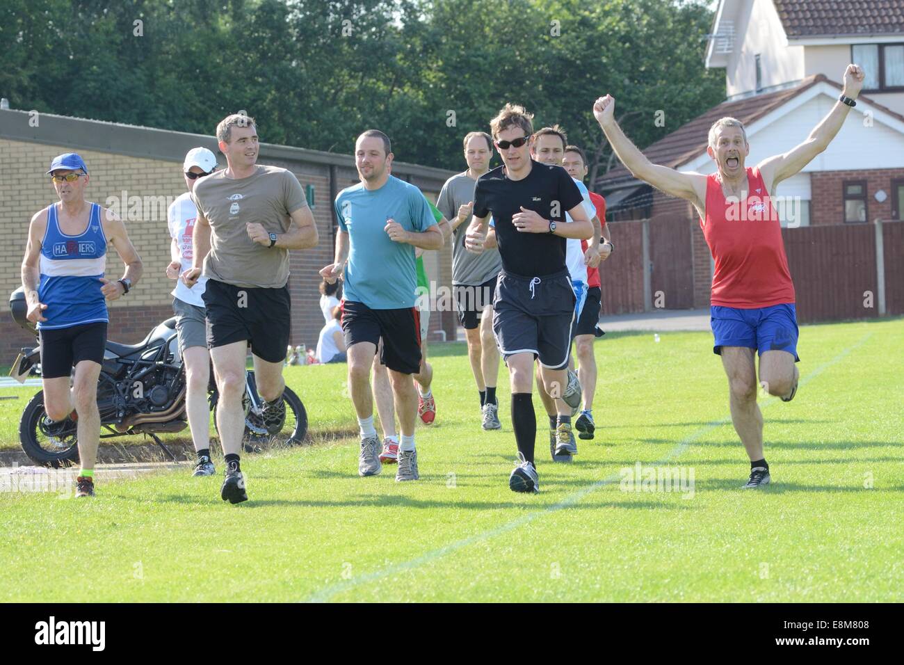 Group of runners cheering Stock Photo - Alamy