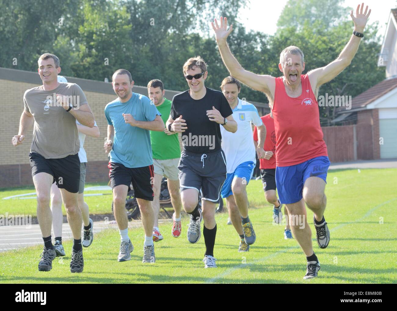Group of runners cheering Stock Photo - Alamy