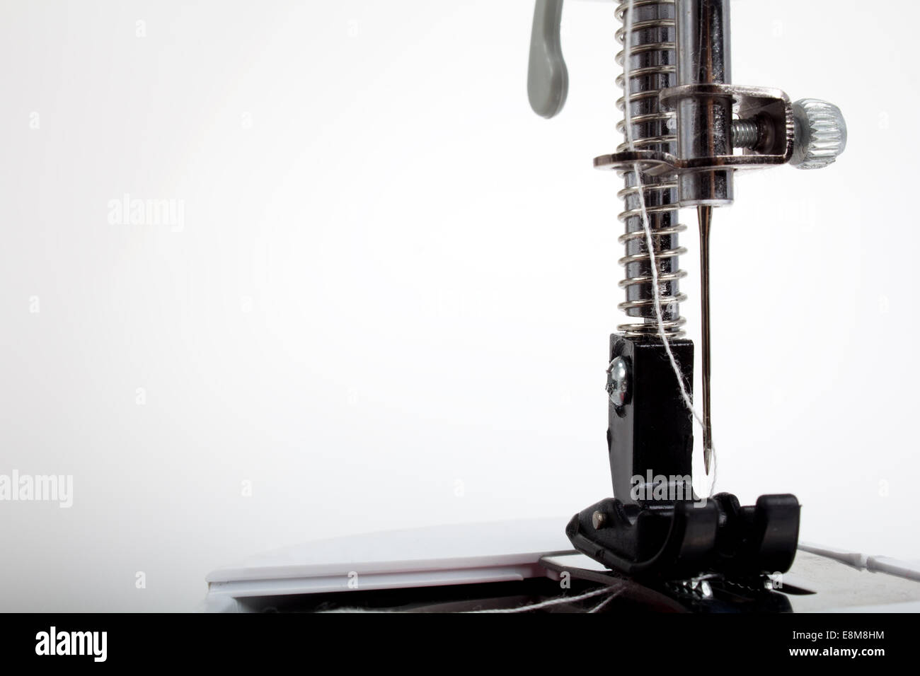 Sewing machine foot and needle close up Stock Photo - Alamy