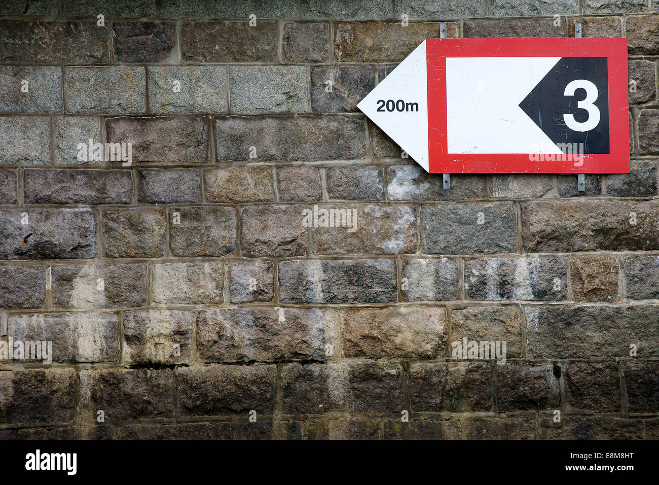 Striking Wall with arrow sign Stock Photo - Alamy