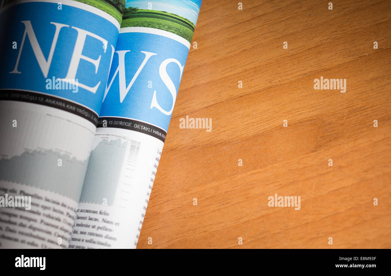 Newspaper on the table with very shallow depth of field and copy space ...