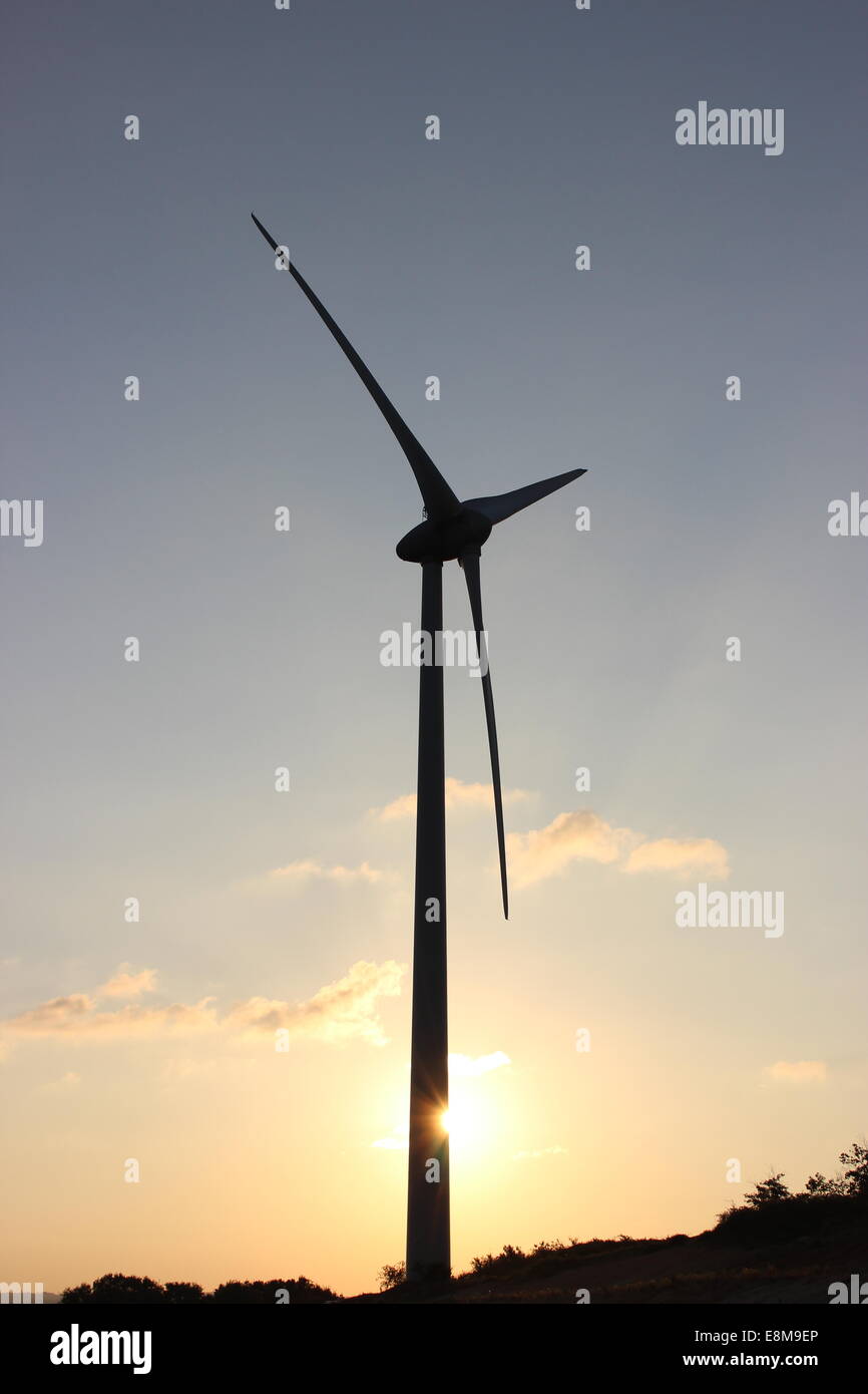 Wind turbine with sun behind Stock Photo - Alamy