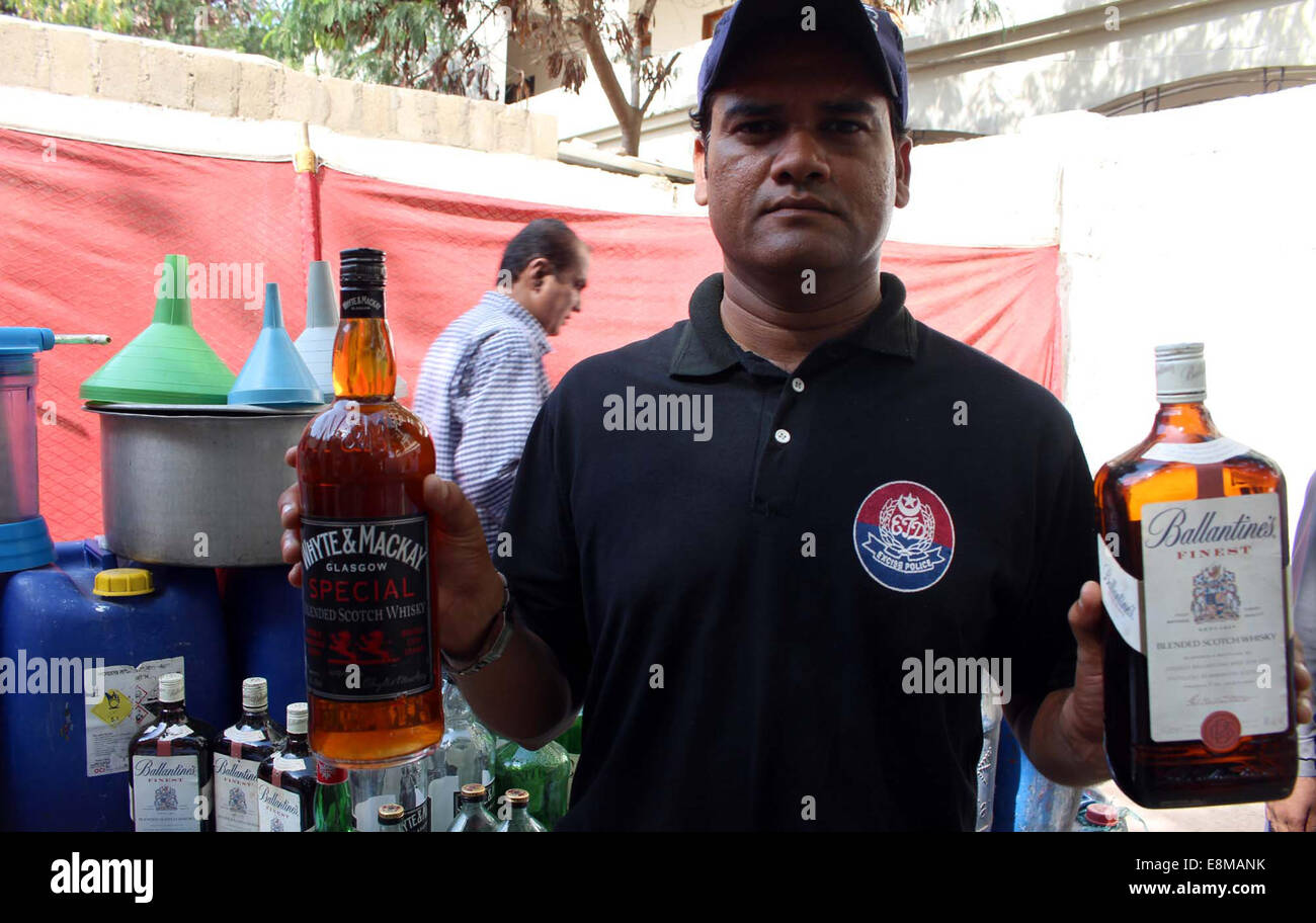 Excise police officials are showing recovered liquor during a raid on a ...