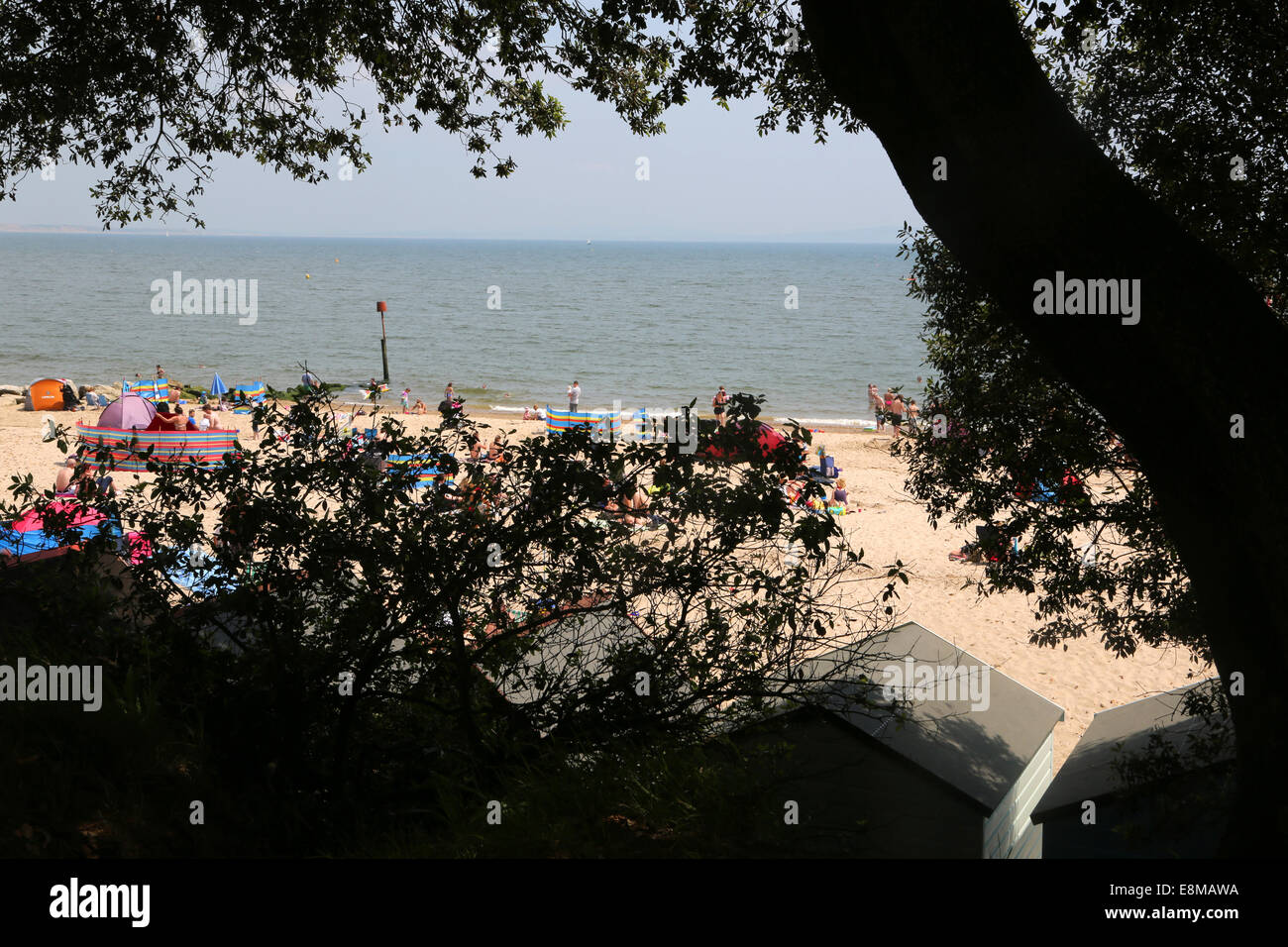 View Through Trees Of People On Avon Beach Mudeford Dorset England ...