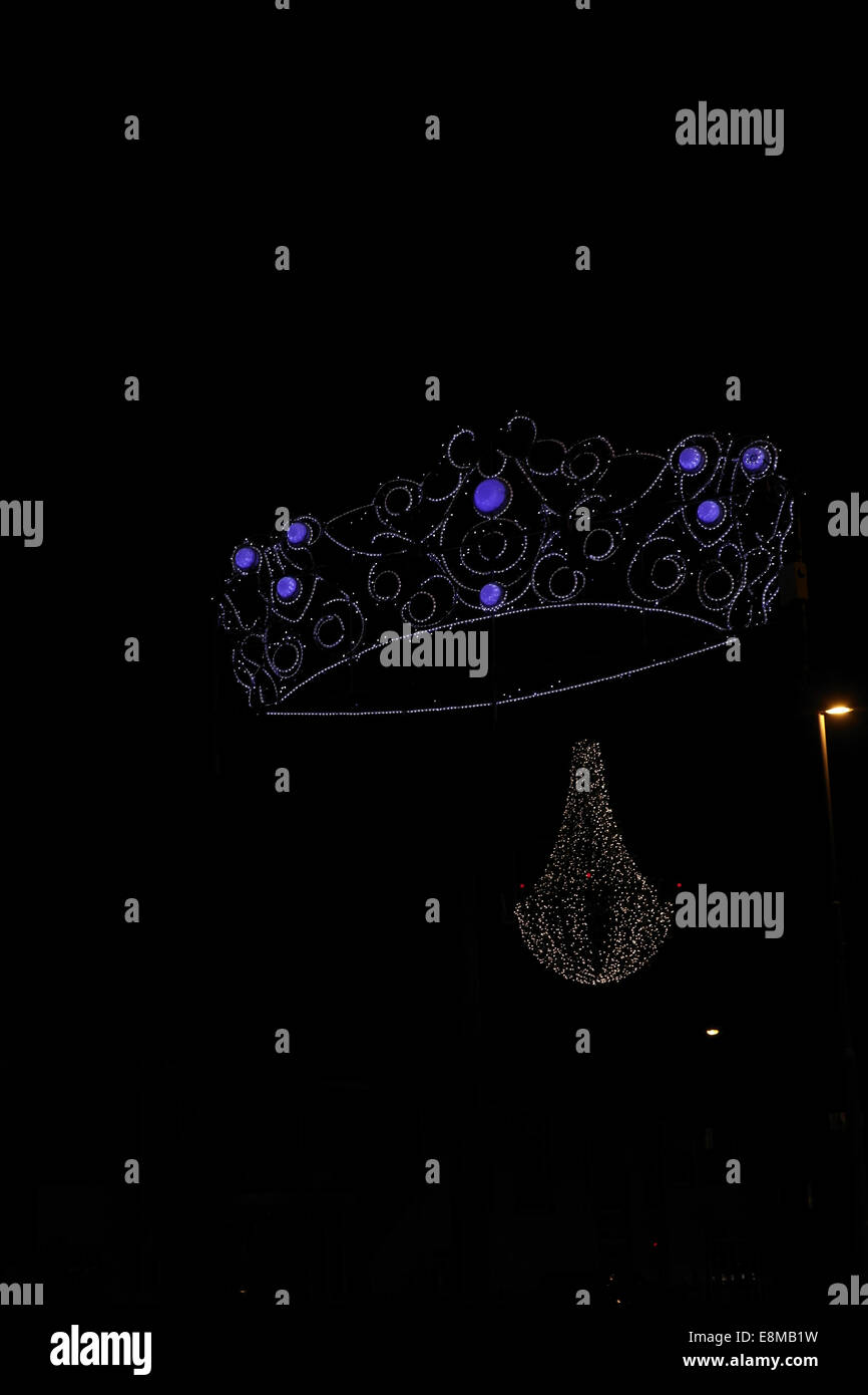 Night portrait blue LED crown and large white candelabra suspended ...