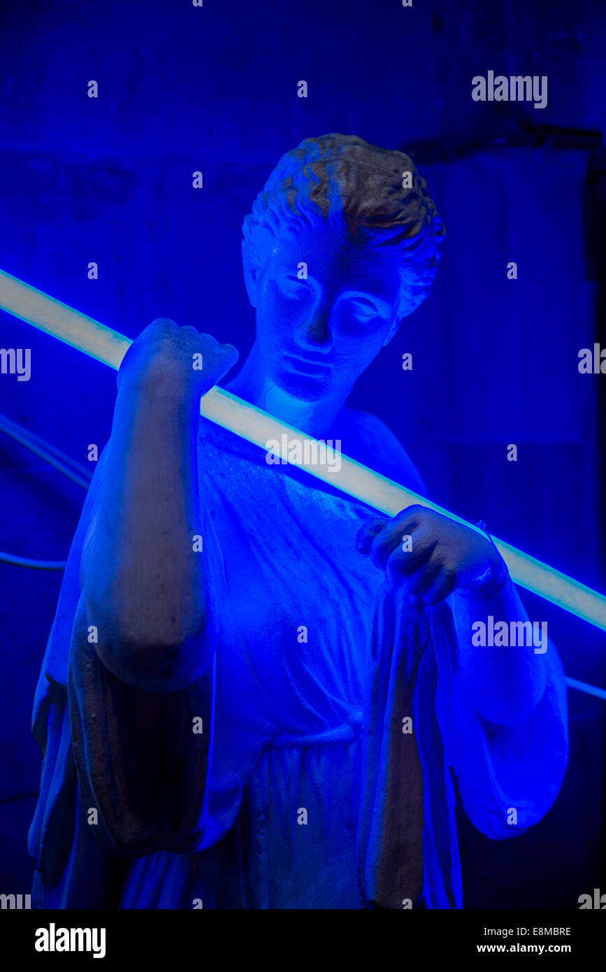 Statue catching a blue fluorescent light Stock Photo - Alamy