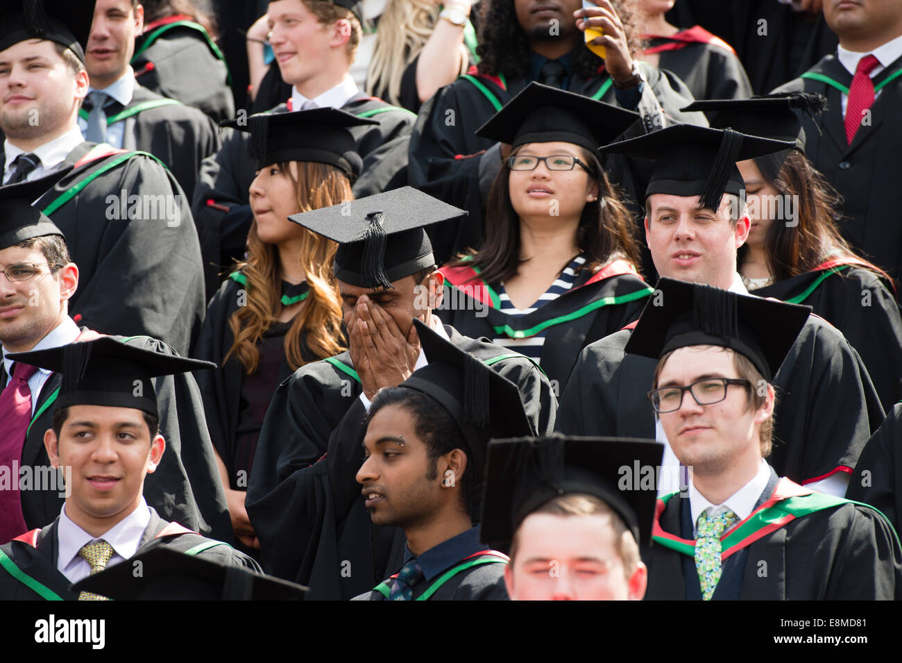 Students in their traditional gowns and mortar boards graduating on ...