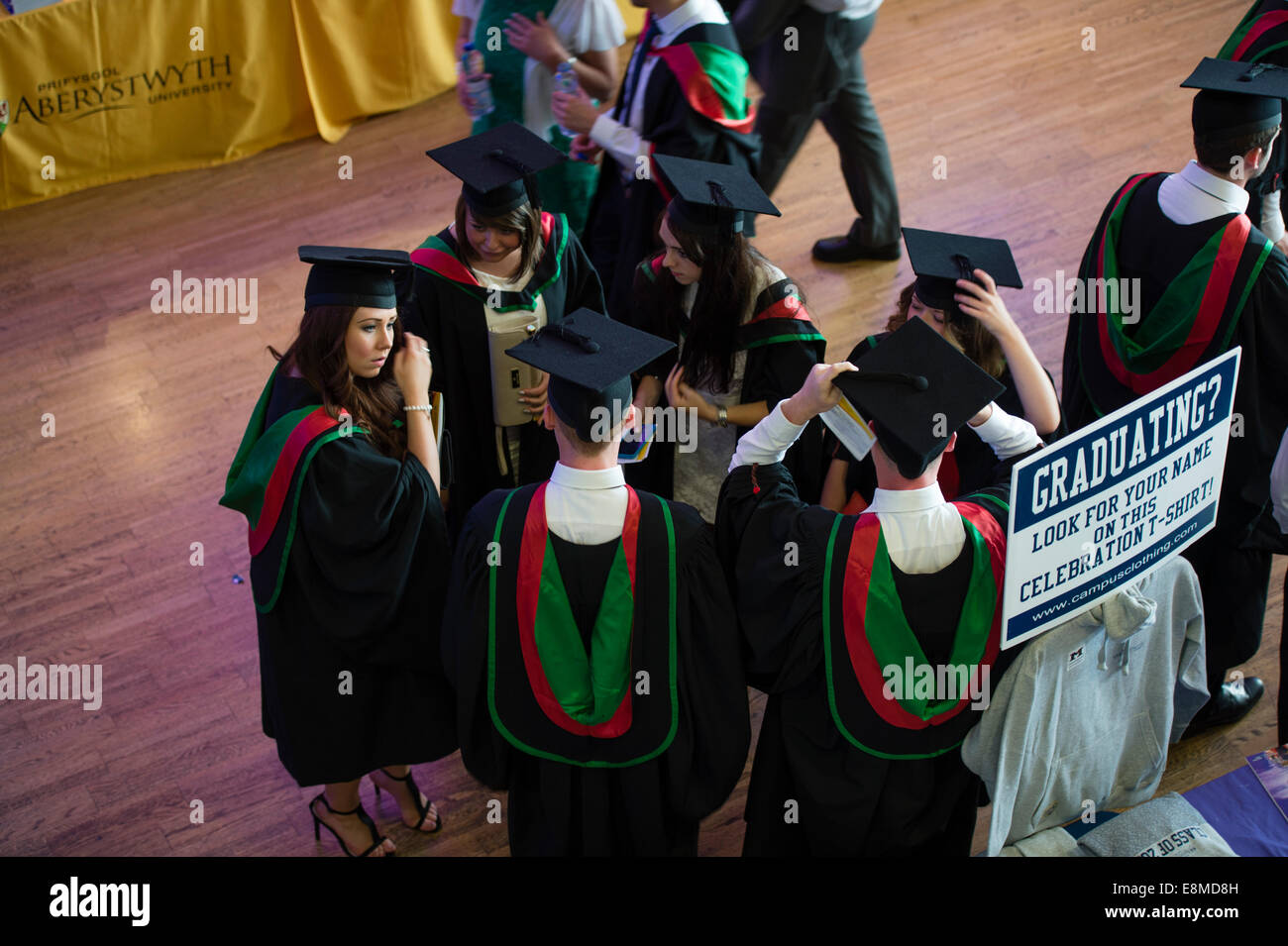 Students in their traditional gowns and mortar boards graduating on ...