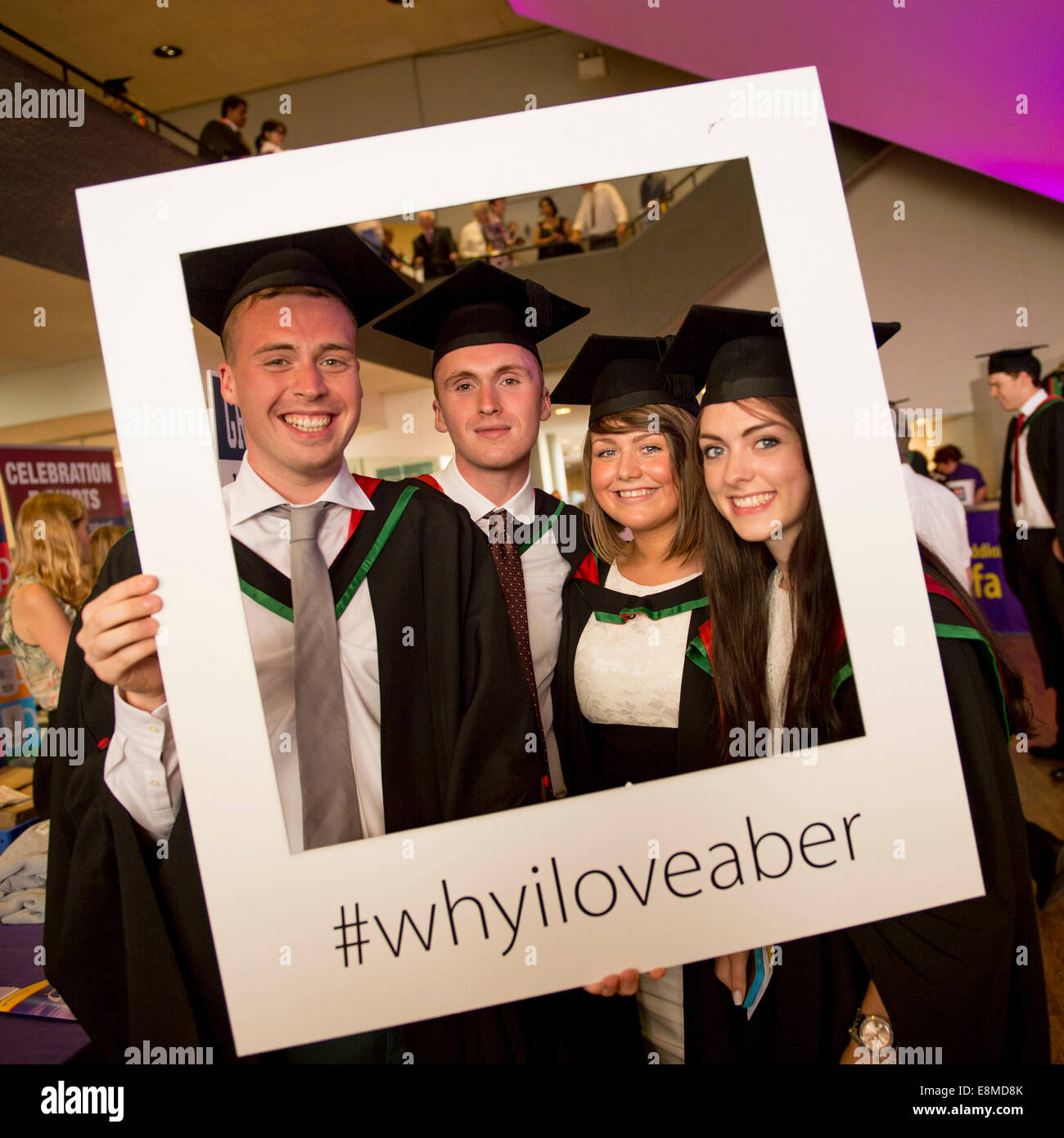 4 four Students in their traditional gowns and mortar boards graduating ...