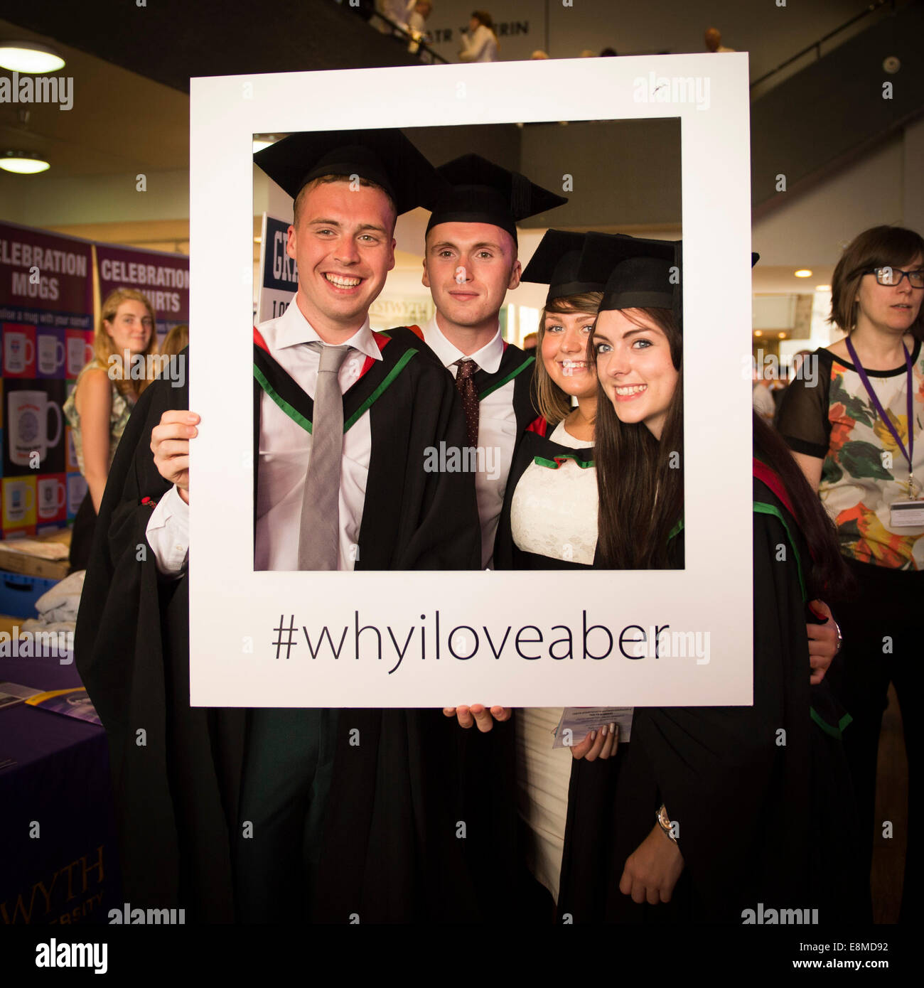 4 four Students in their traditional gowns and mortar boards graduating ...