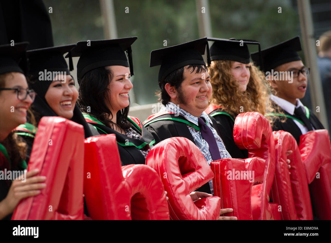 Students in their traditional gowns and mortar boards graduating on ...
