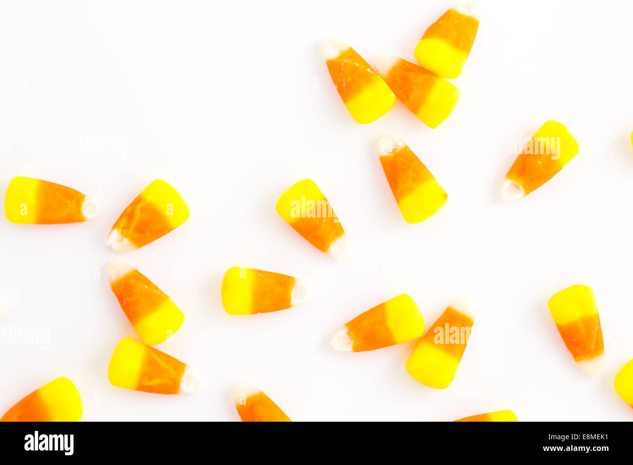 Candy corn candies on a white background Stock Photo - Alamy