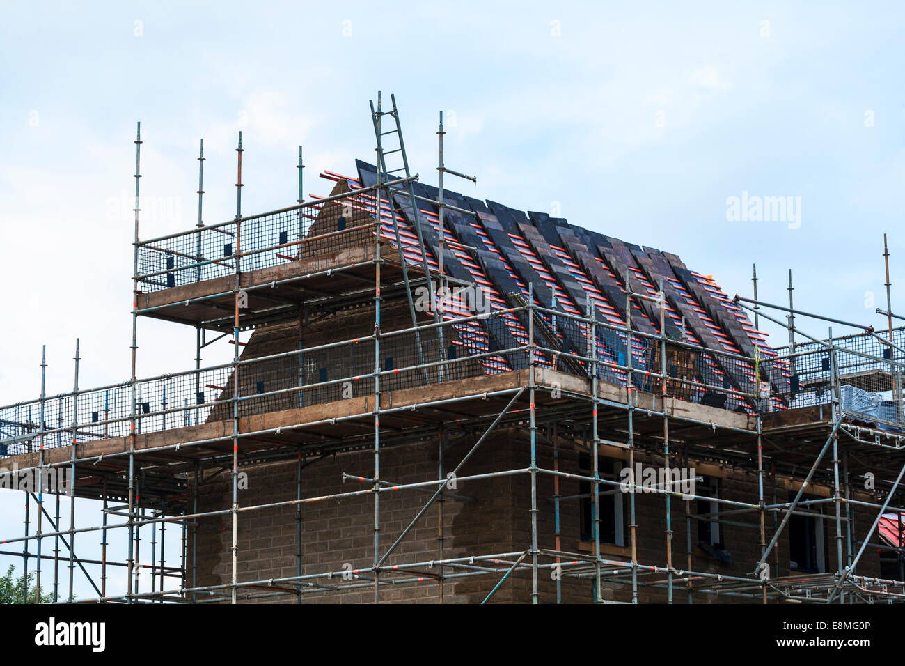 An image of a house being constructed, showing scaffolding, safety rail ...