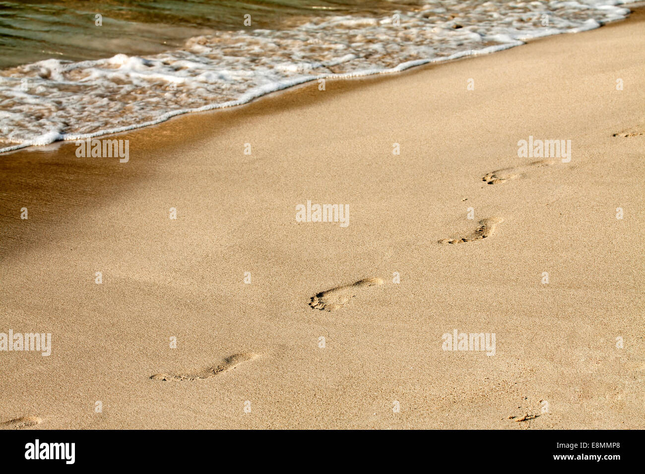 Footsteps in the sand at the beach Stock Photo - Alamy