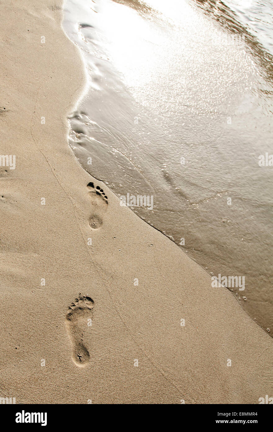 Footsteps in the sand at the beach Stock Photo - Alamy
