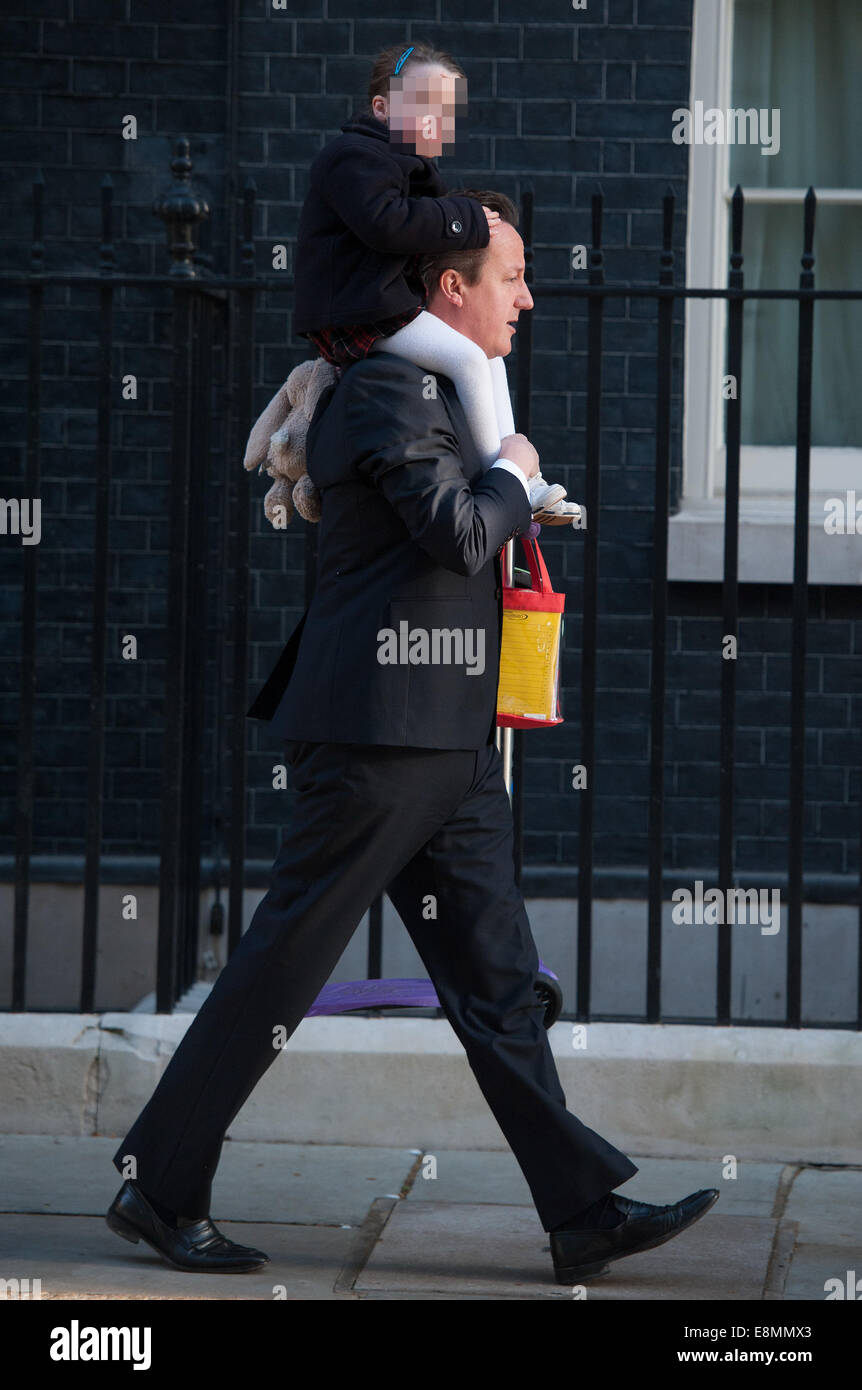 David Cameron leaves Downing Street carrying his daughter Nancy on his ...