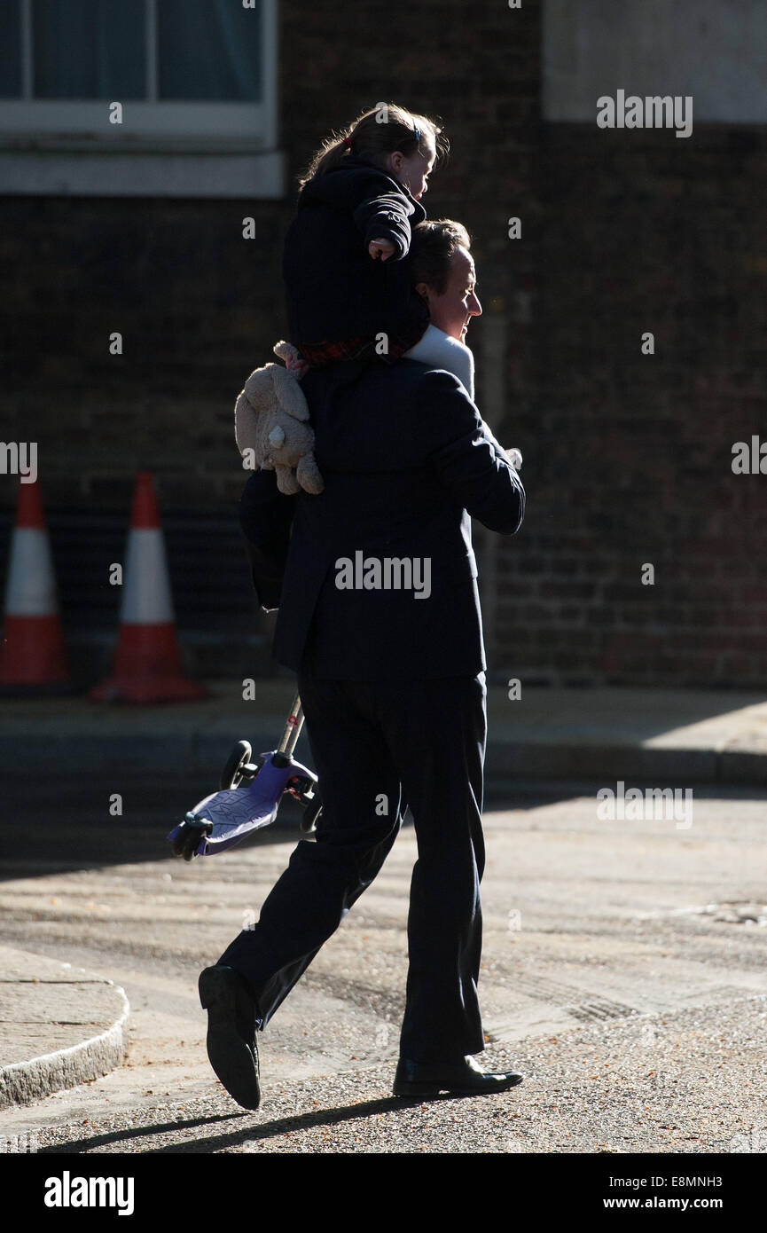 David Cameron leaves Downing Street carrying his daughter Nancy on his ...
